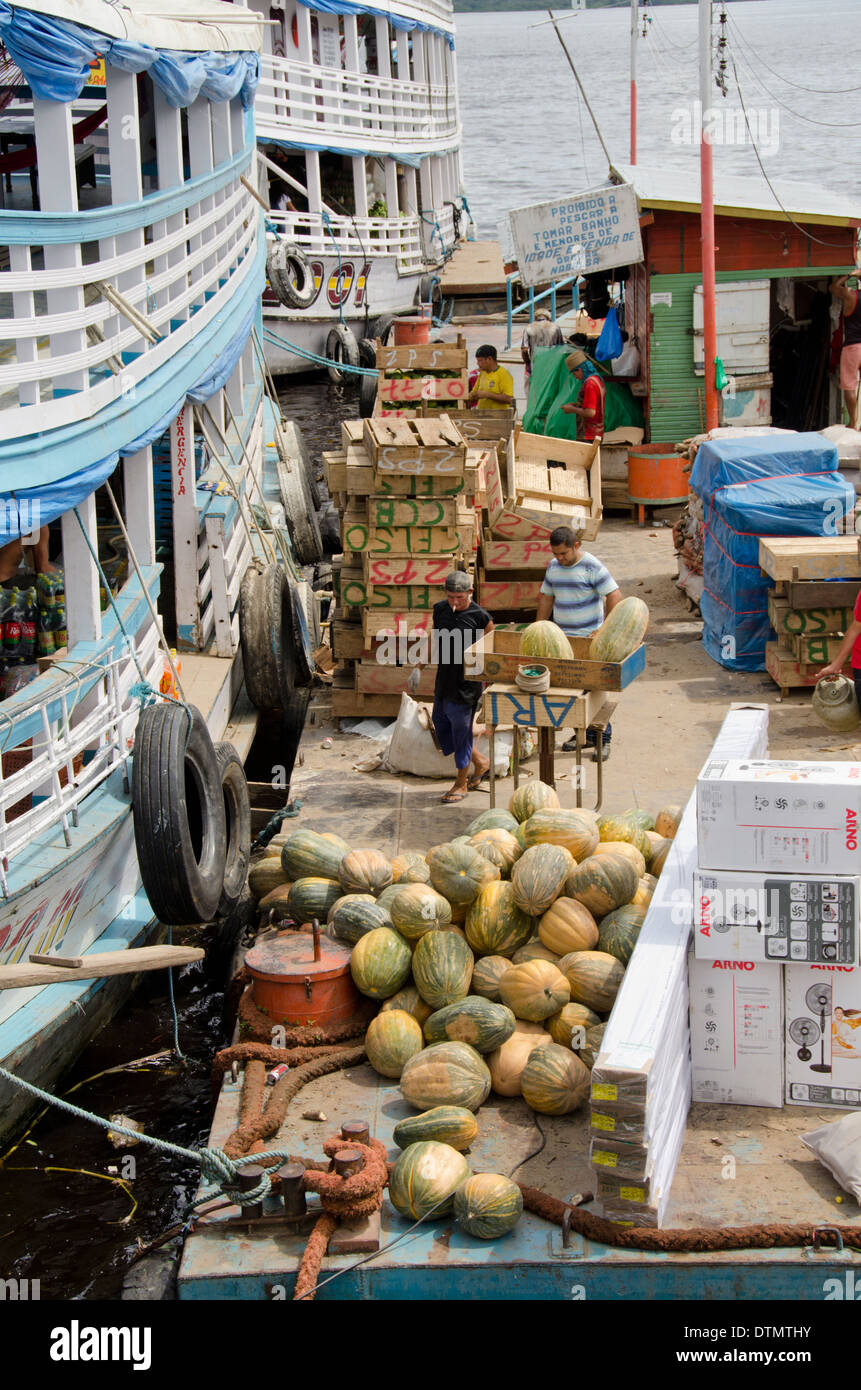 Brazil, Amazon, Manaus. Busy waterfront pier where local riverboats are ...