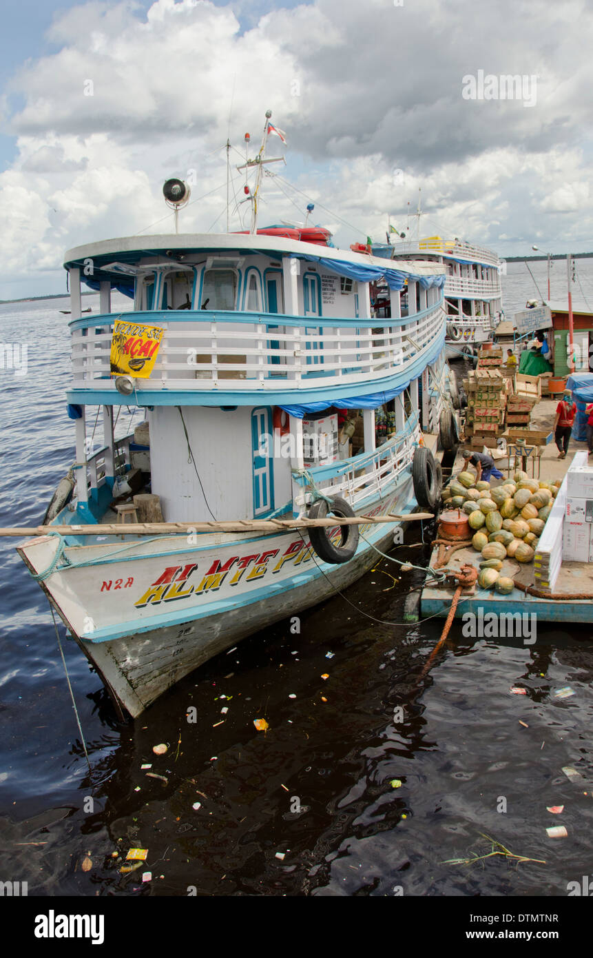 Brazil, Amazon, Manaus. Busy waterfront pier where local riverboats are ...