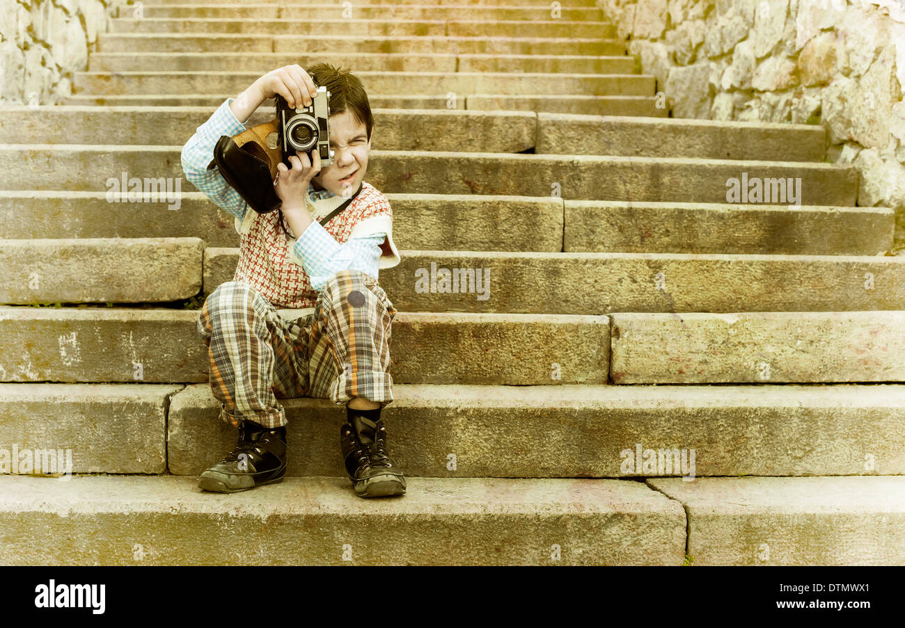 Child with vintage camera. Exterior stairs Stock Photo - Alamy