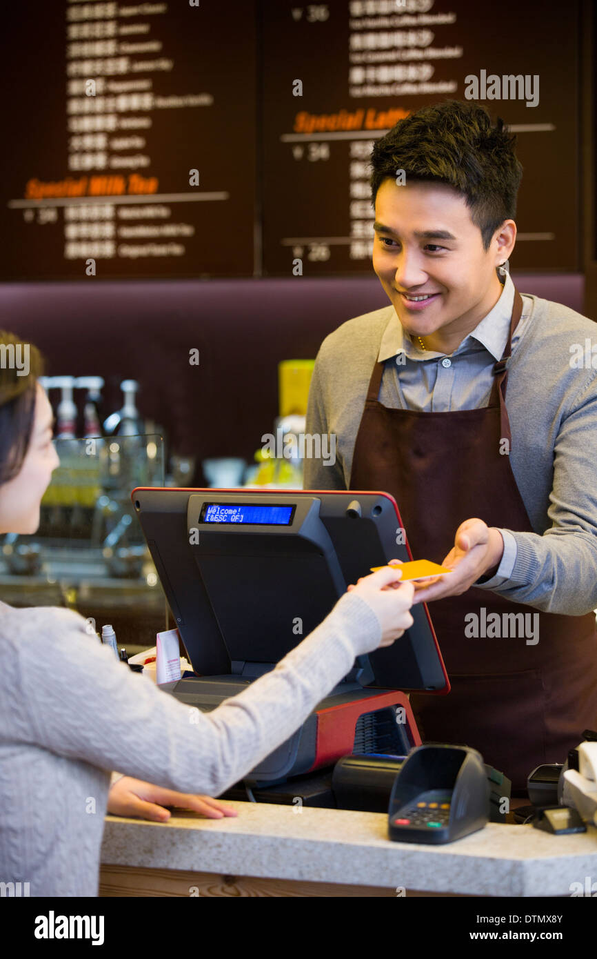 Customer paying by credit card in coffee shop Stock Photo - Alamy