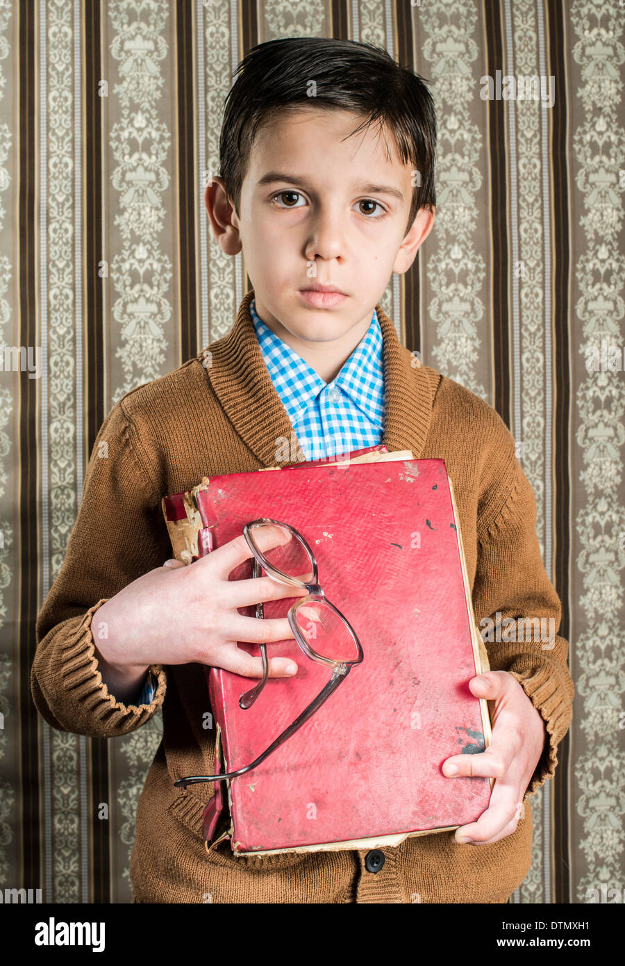 Child with red vintage book. Vintage clothes Stock Photo - Alamy