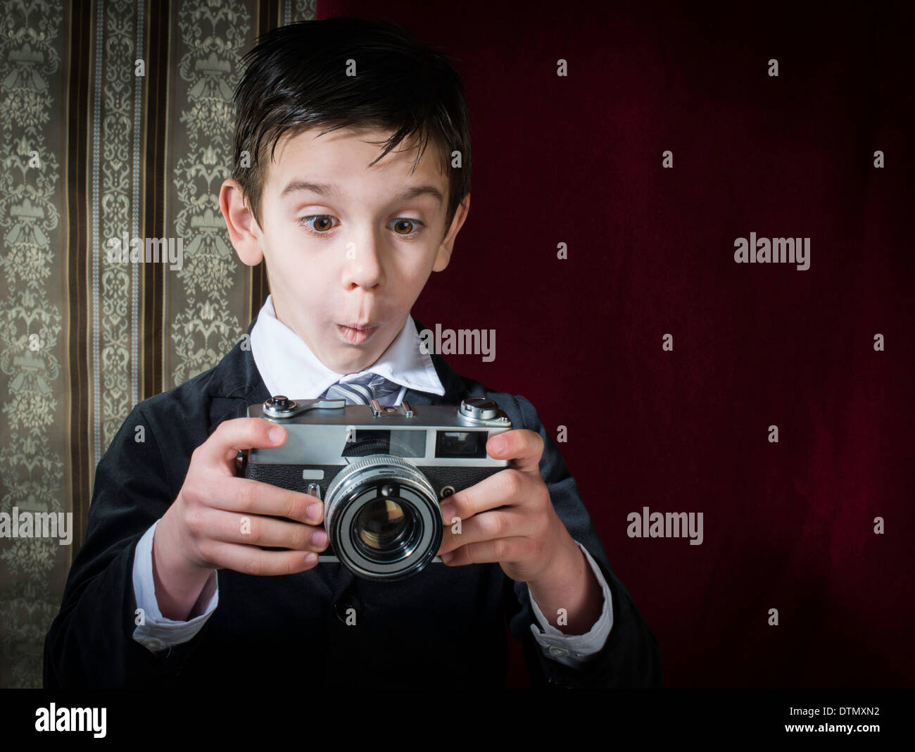 Boy with vintage camera. Vintage clothes Stock Photo - Alamy