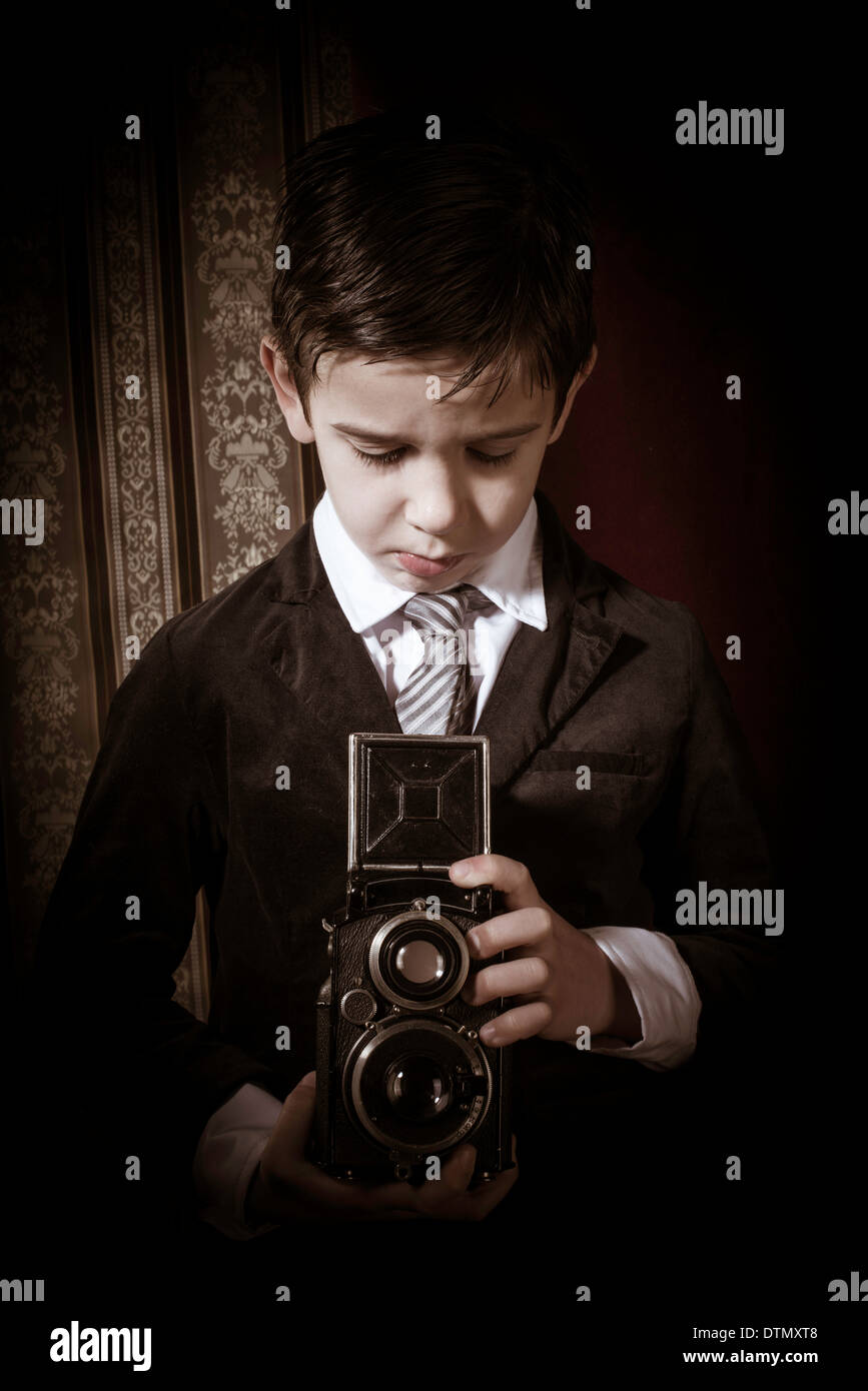 Boy with vintage camera. Vintage clothes Stock Photo - Alamy