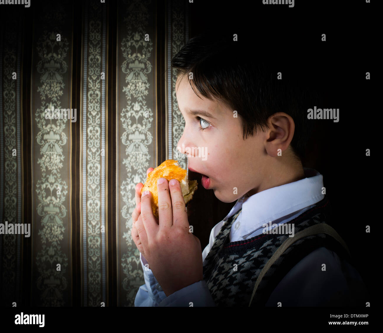 Child who eat donut. Vintage clothes and background Stock Photo - Alamy