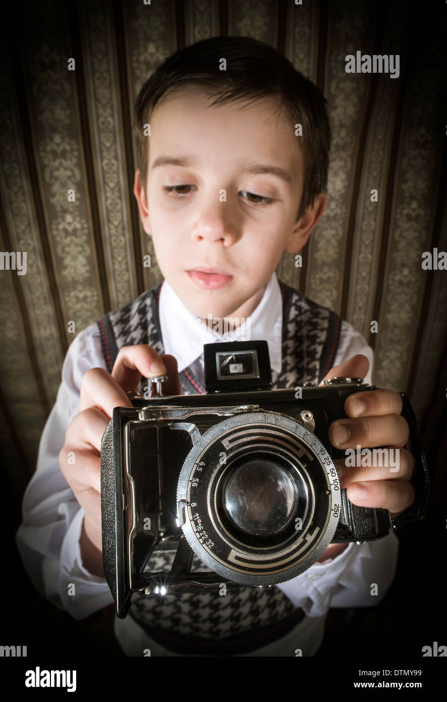 Boy with vintage camera. Vintage clothes Stock Photo - Alamy