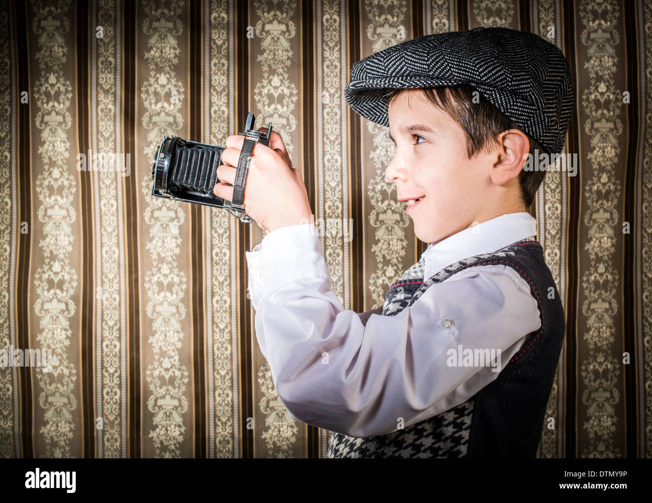 Boy with vintage camera. Vintage clothes Stock Photo - Alamy
