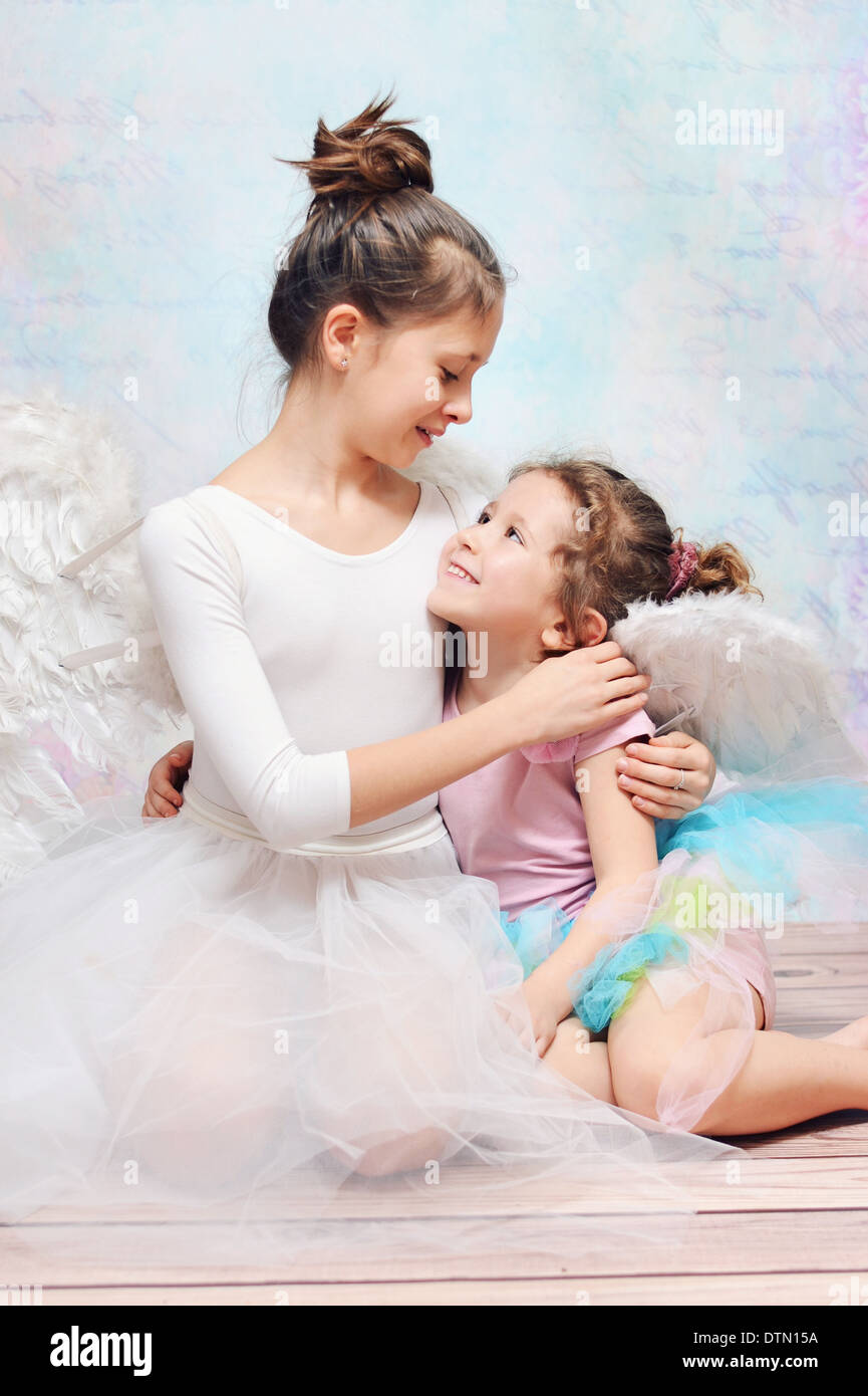 Elder ballet dancer hugging her little cute sister Stock Photo - Alamy