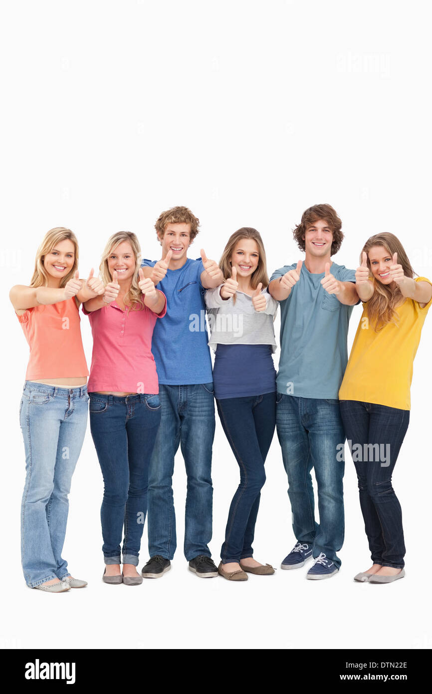 A group smiling and giving the thumbs up Stock Photo - Alamy