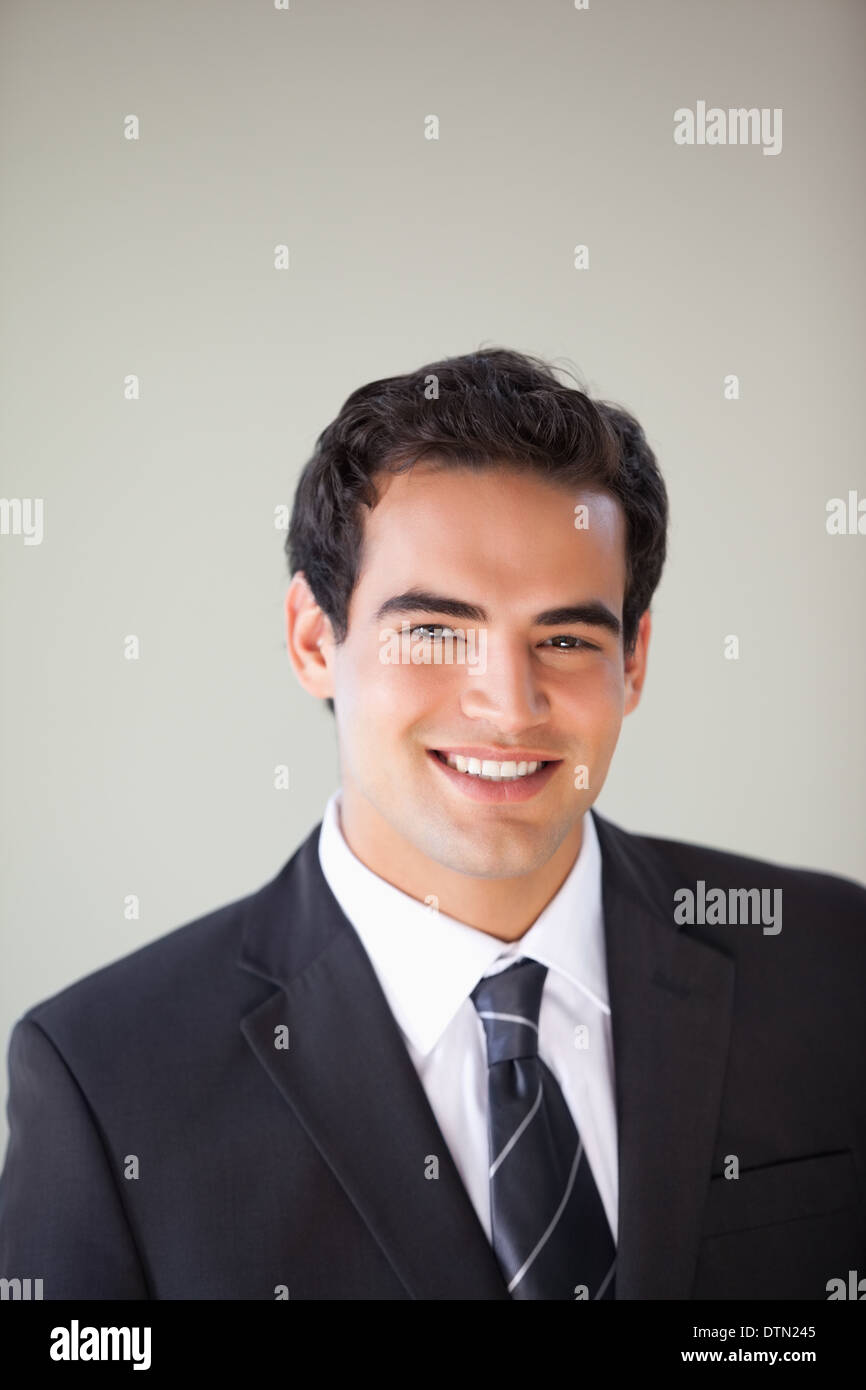 Businessman standing while smiling Stock Photo - Alamy