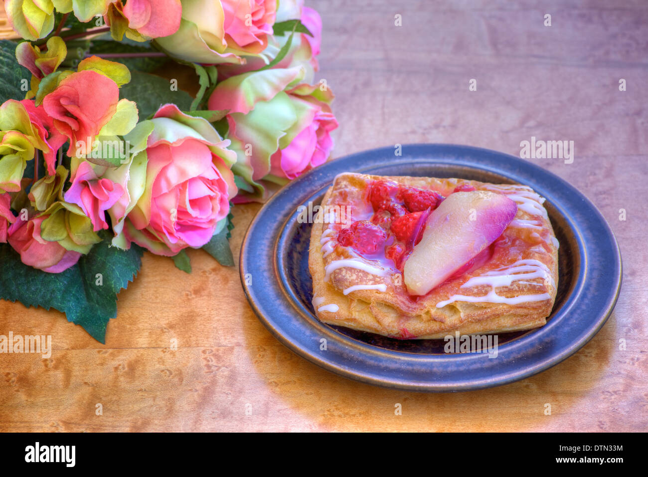 Close-up of a fresh fruit pastry and roses on a wooden background Stock ...