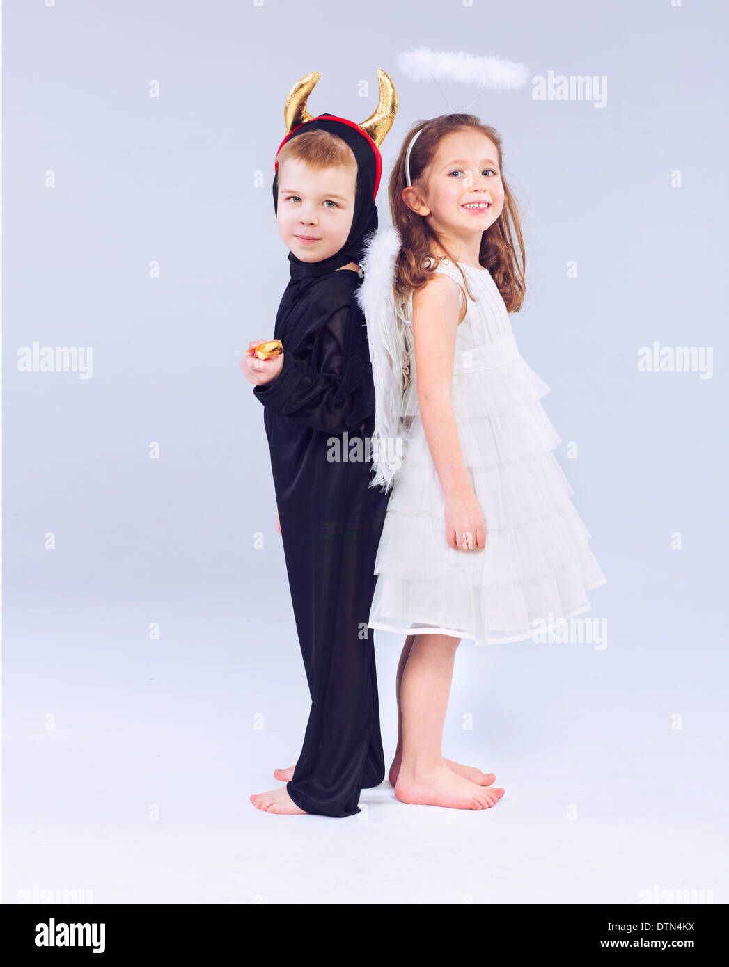 Cute little kids as devil and angel Stock Photo - Alamy