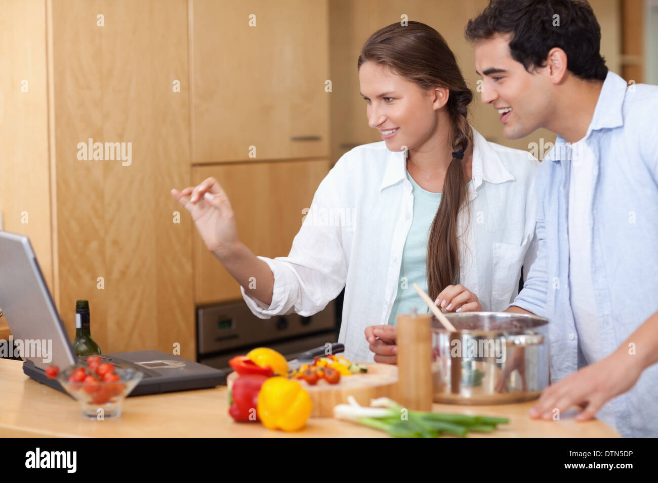 Couple cooking together using a recipe hi-res stock photography and ...