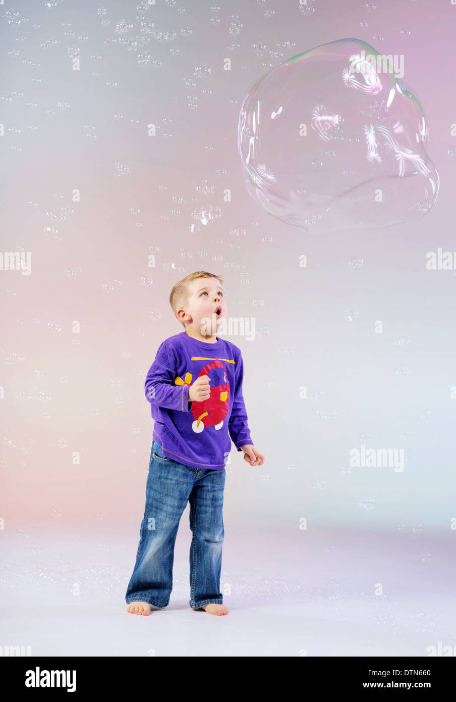 Cute little boy enjoying big soap bubbles Stock Photo - Alamy