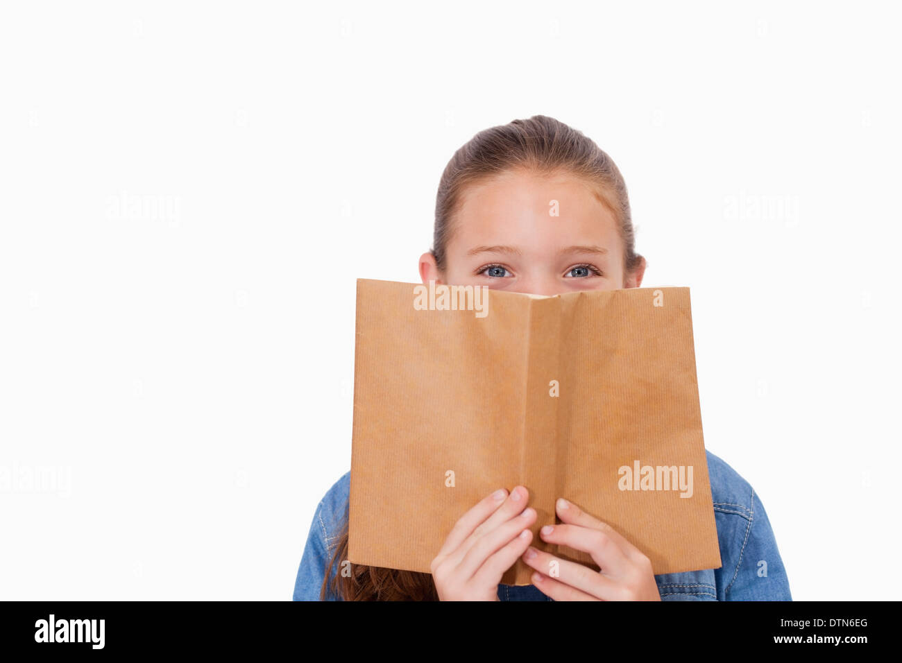 Girl hiding her face behind a book Stock Photo - Alamy
