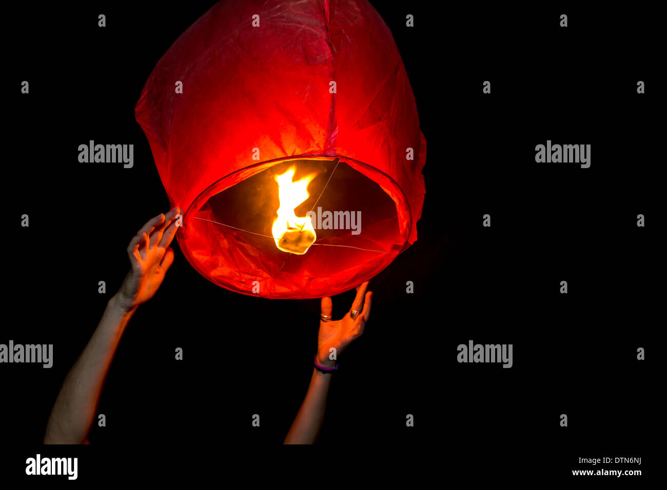 Launching a sky lantern in the night Stock Photo - Alamy