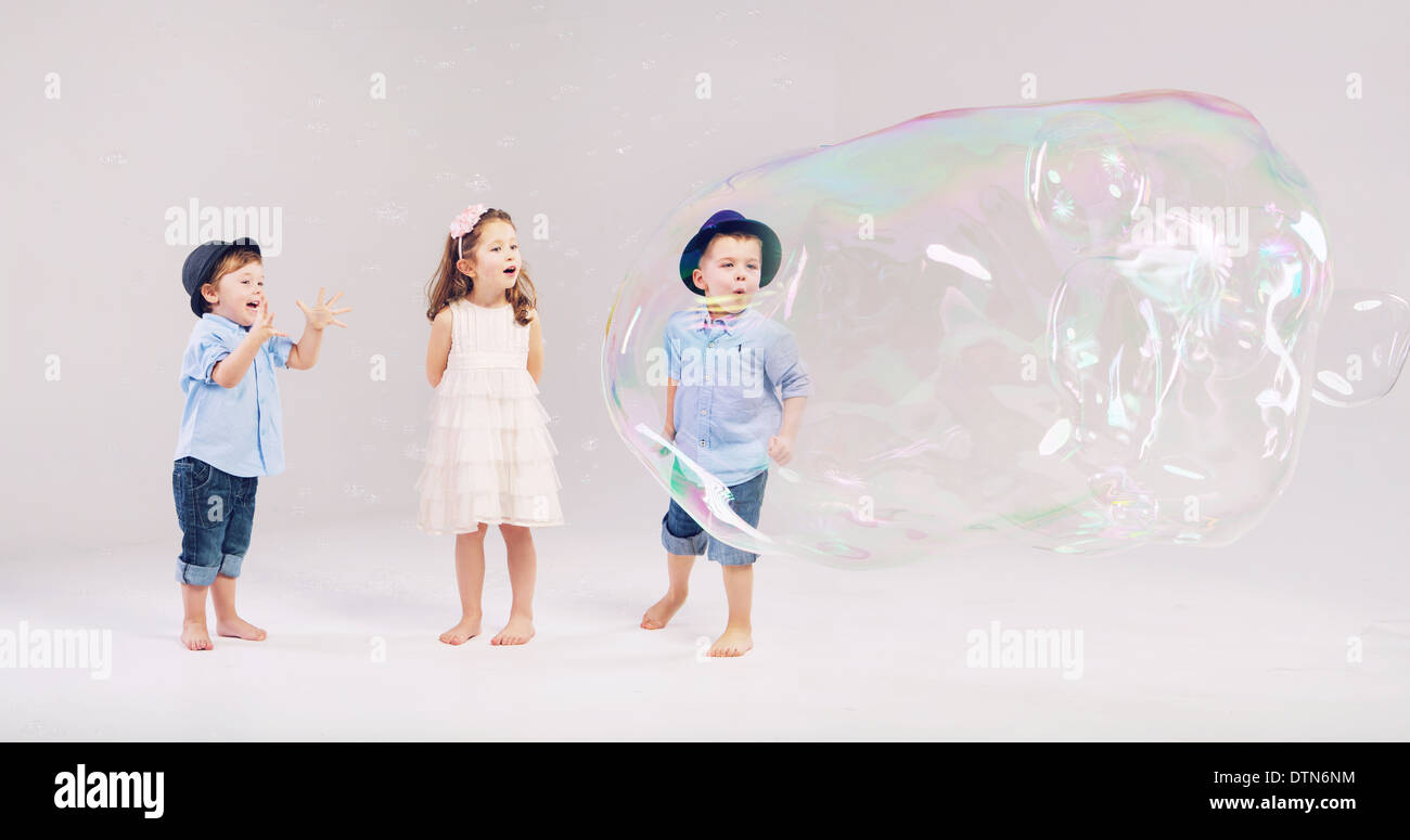 Two little gentlemen playing with their cute friend Stock Photo - Alamy