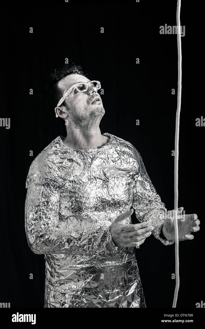 Spaceman with rope looking up Stock Photo - Alamy