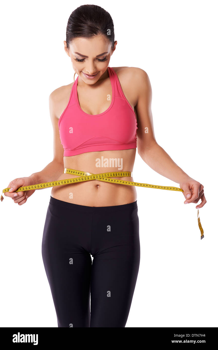 Female athlete measuring her waist Stock Photo - Alamy