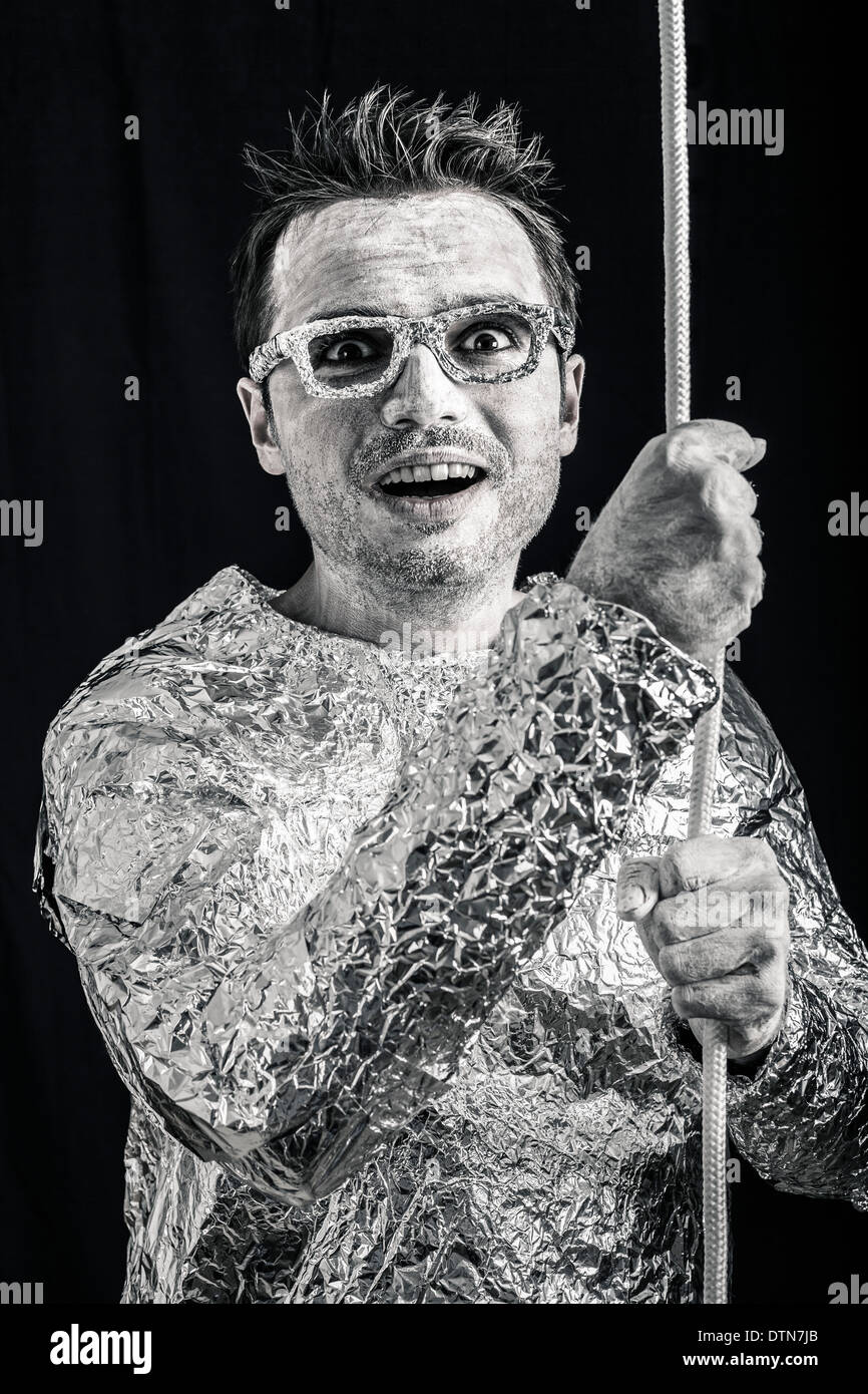 Funny spaceman holding rope Stock Photo - Alamy