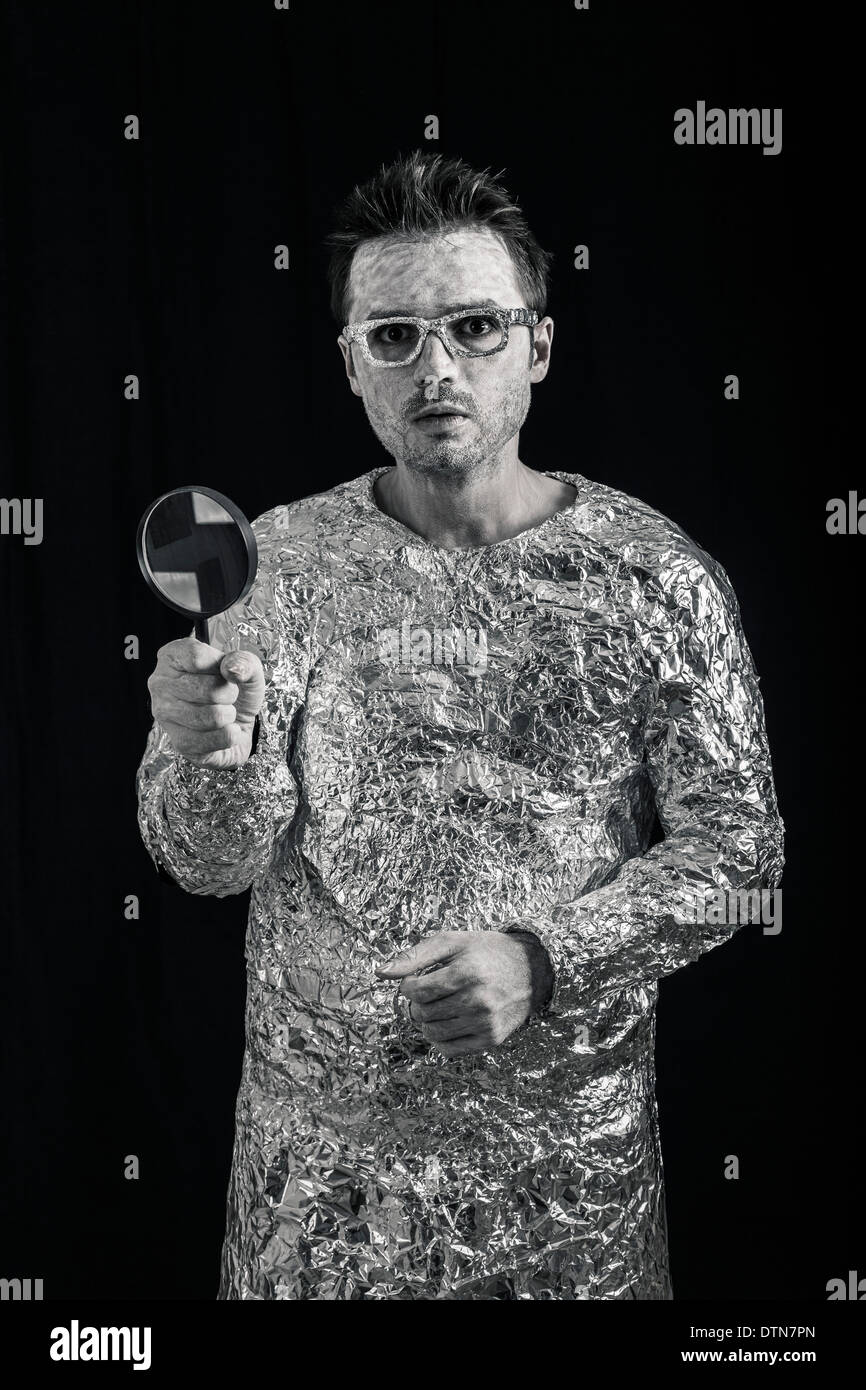 Funny spaceman holding magnifying glass Stock Photo - Alamy