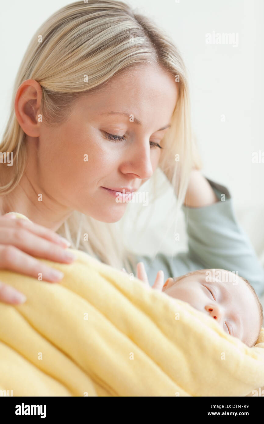 Mother resting next to her sleeping baby Stock Photo - Alamy