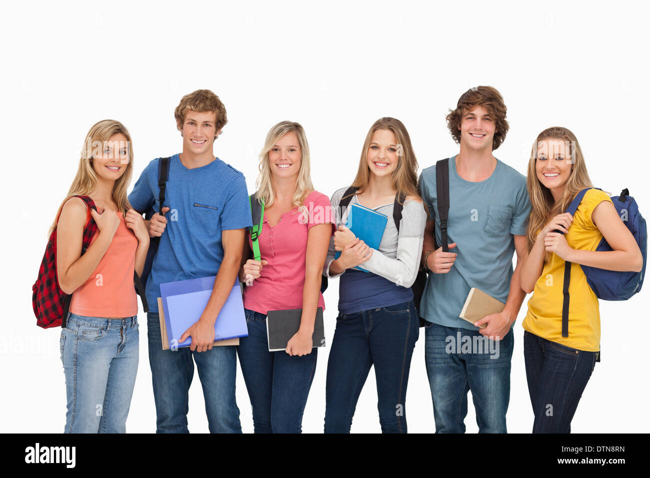 Smiling students all geared up for college Stock Photo - Alamy