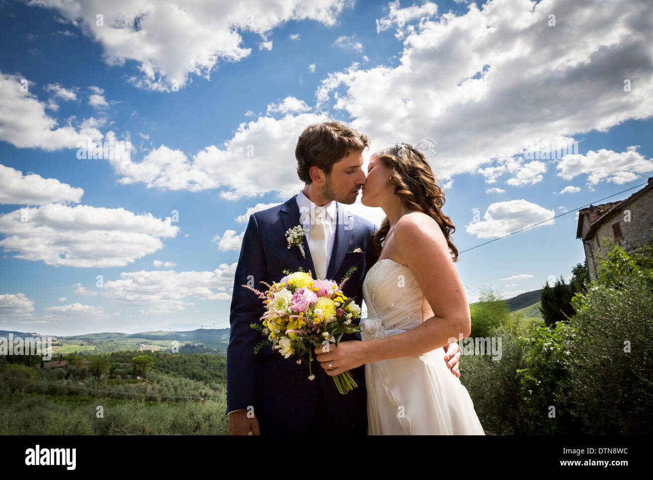 Bride and groom kissing Stock Photo - Alamy