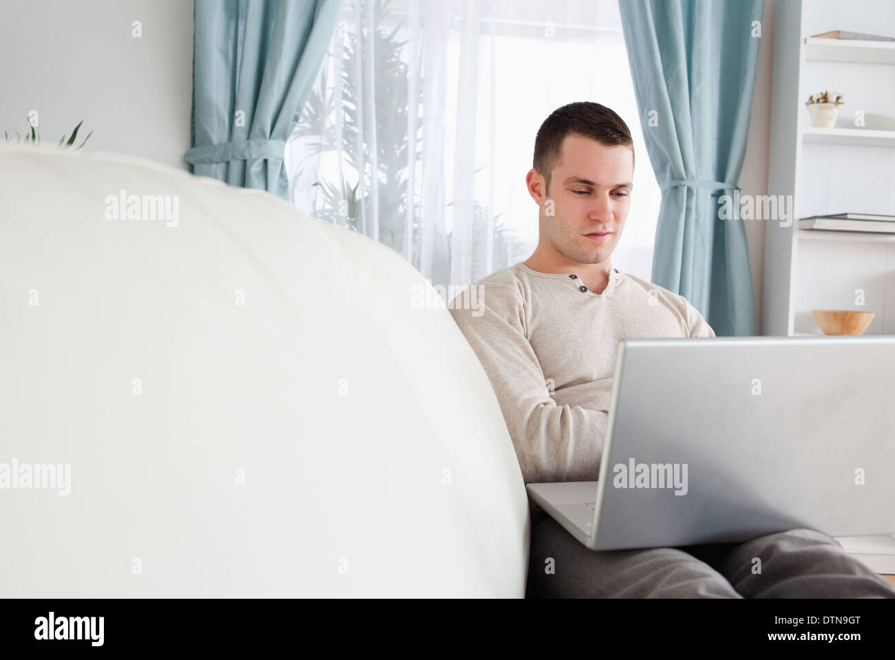 Handsome man working with his notebook Stock Photo - Alamy