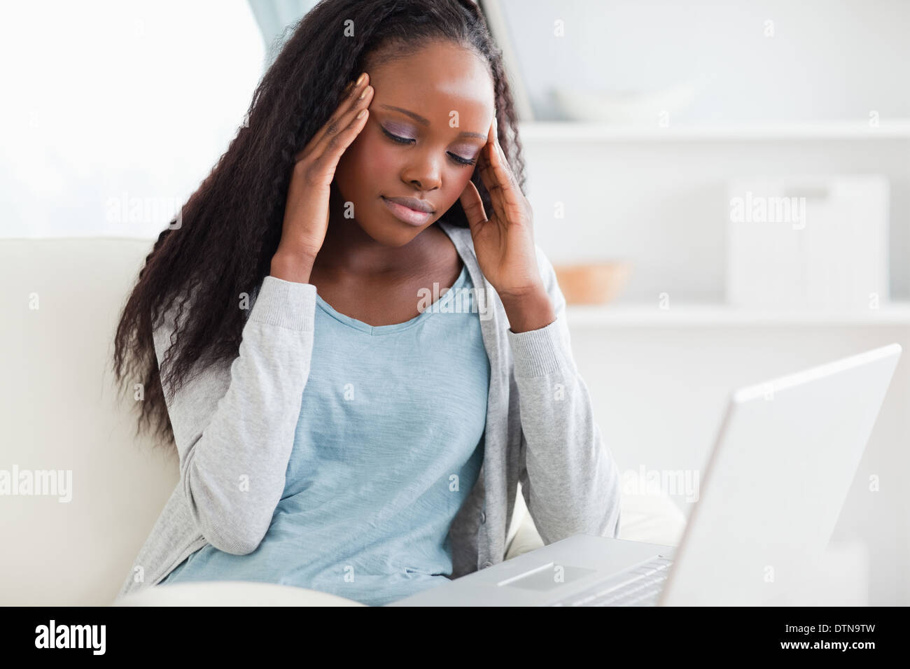 Laptop causes headache to woman Stock Photo - Alamy
