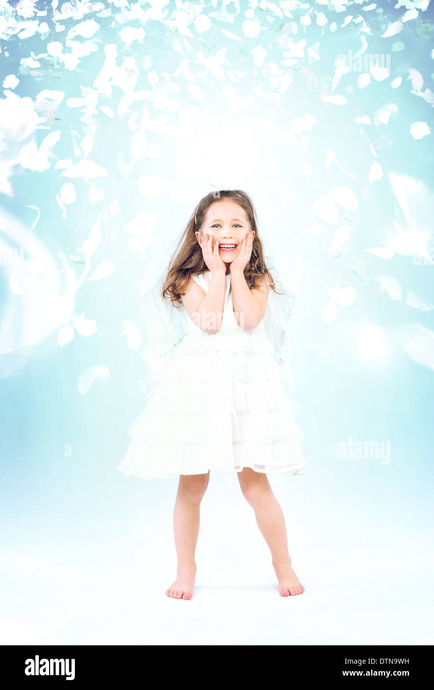 Cute little girl among flying rose petals Stock Photo - Alamy