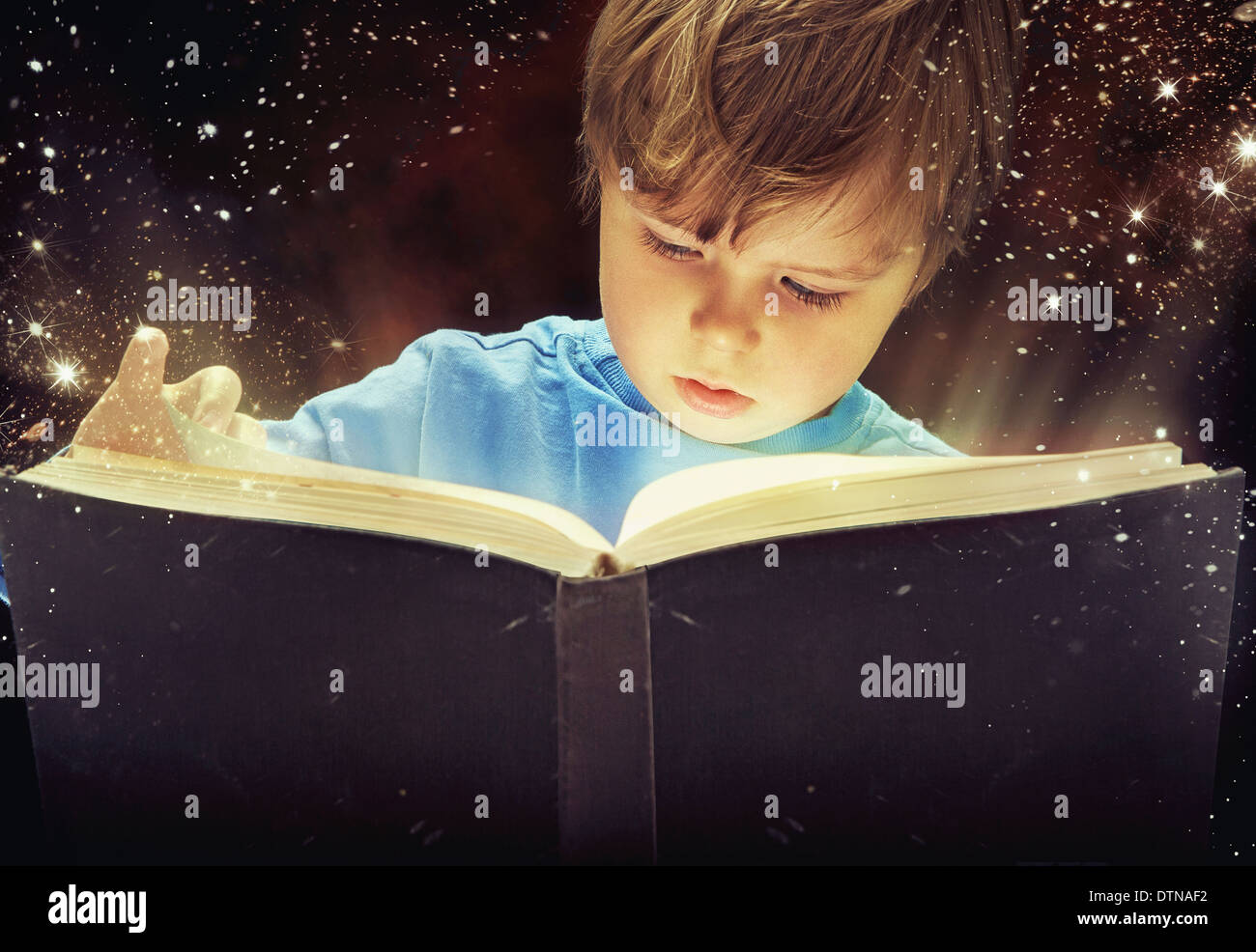 Amazed young boy with the magic book Stock Photo - Alamy