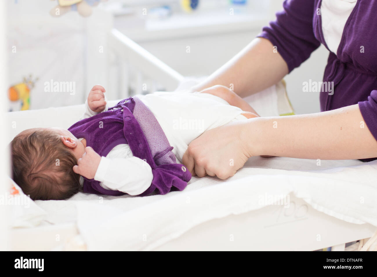 Mother changing diapers of newborn baby Stock Photo - Alamy