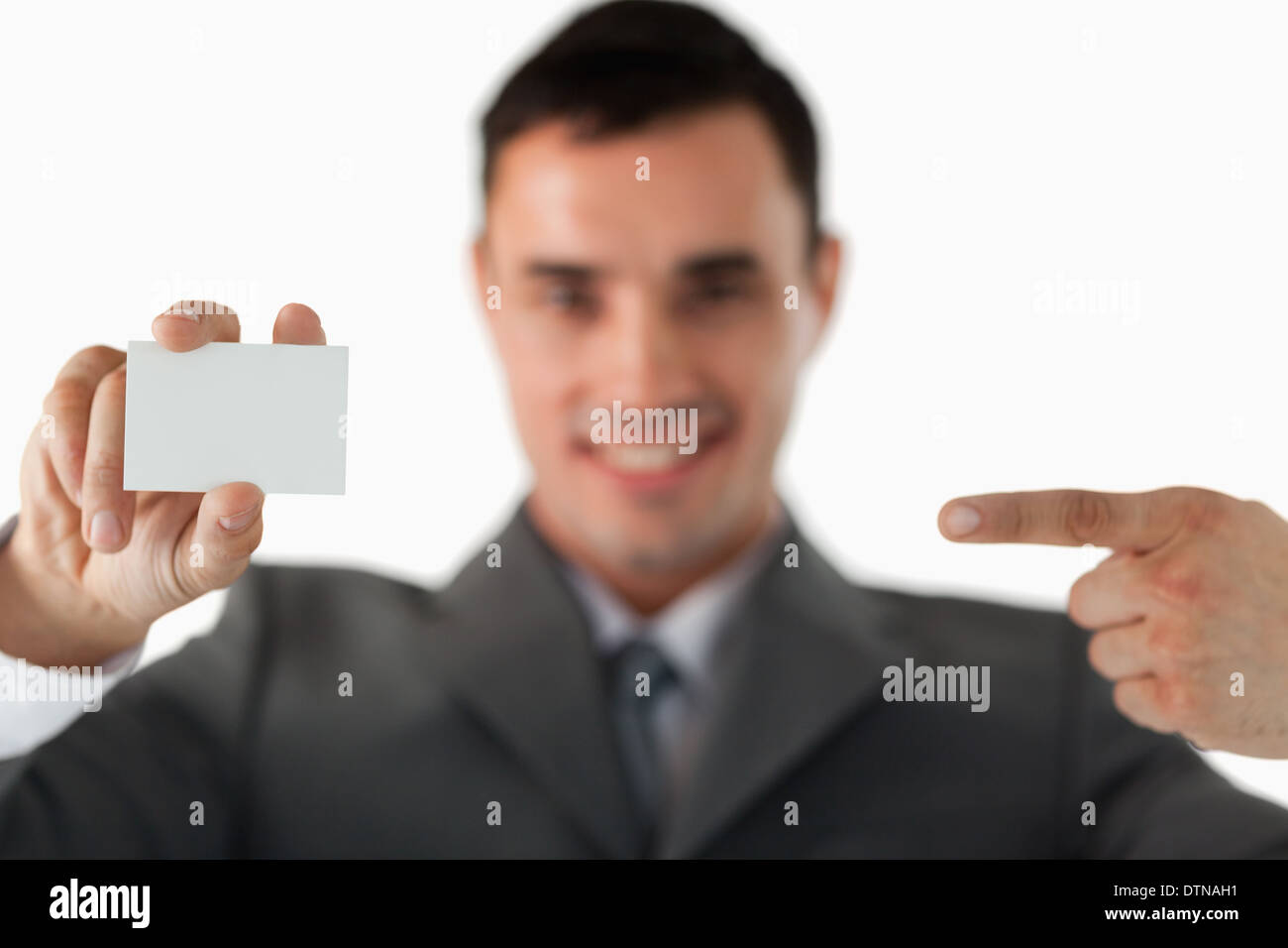 Businessman pointing at business card Stock Photo - Alamy