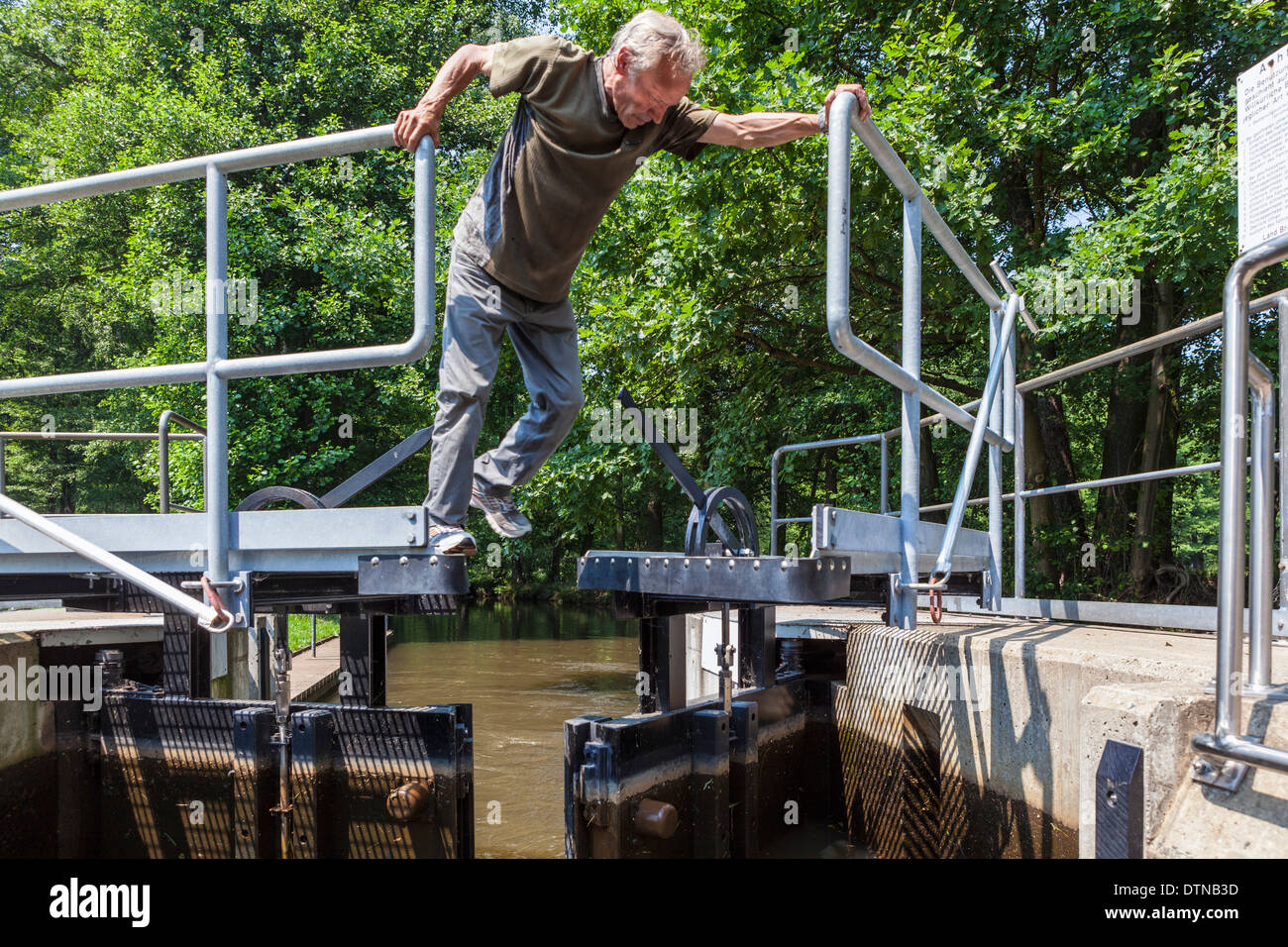 Lockkeeper opens doors of lock that regulates water levels in an ...