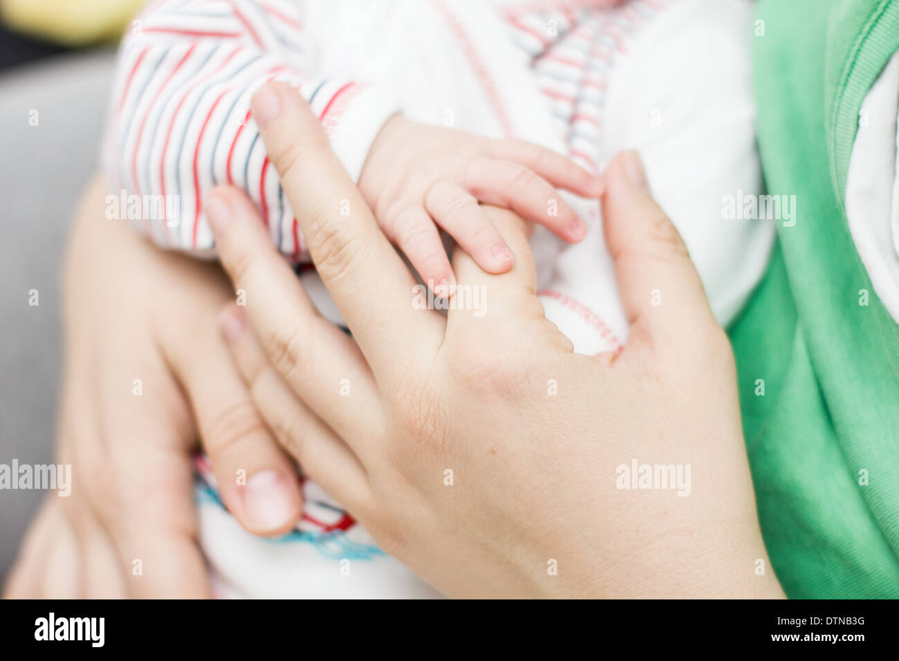Mother holding newborn baby hand Stock Photo - Alamy
