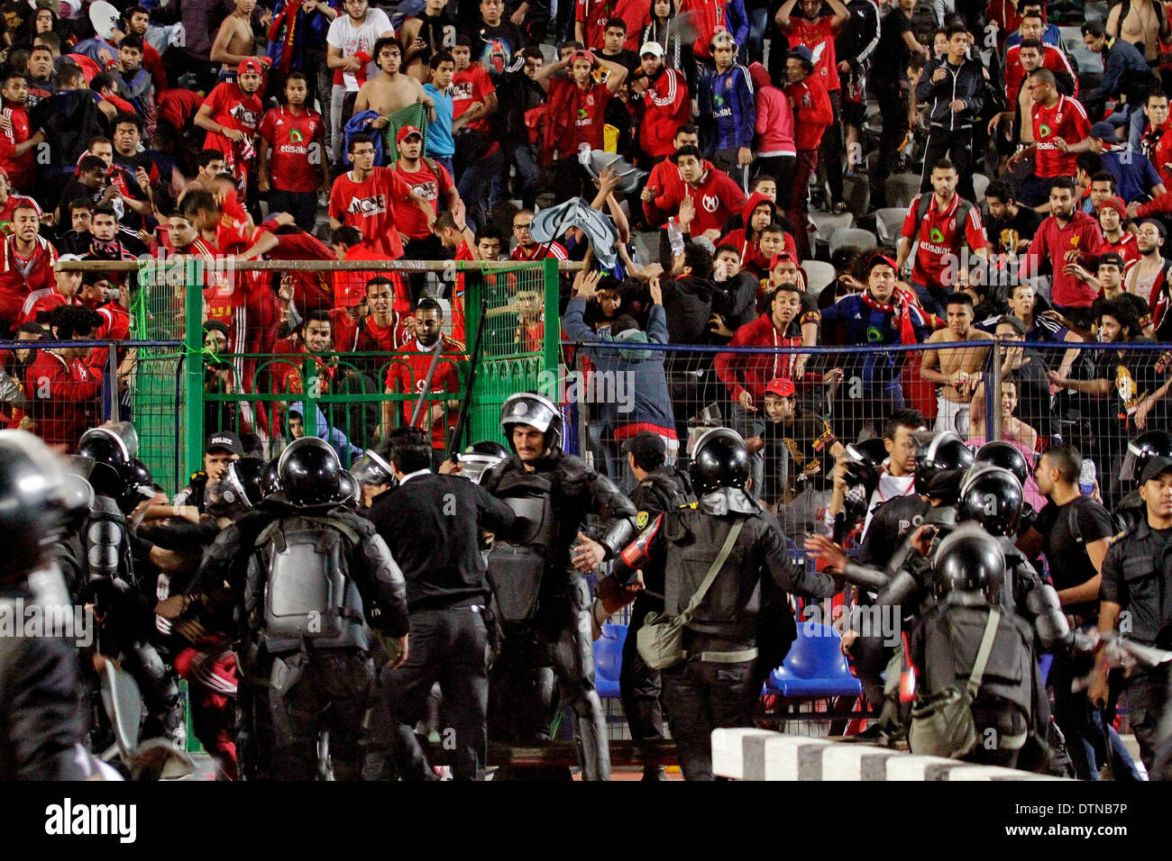 Cairo, Egypt. 20th Feb, 2014. Fans of Al-Ahly clash with riot police ...