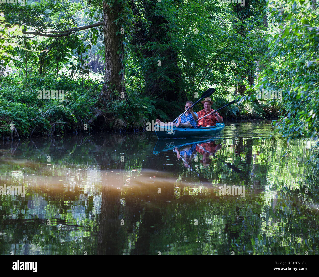 Two men in a kayak rowing on an irrigation canal in the Spreewald ...