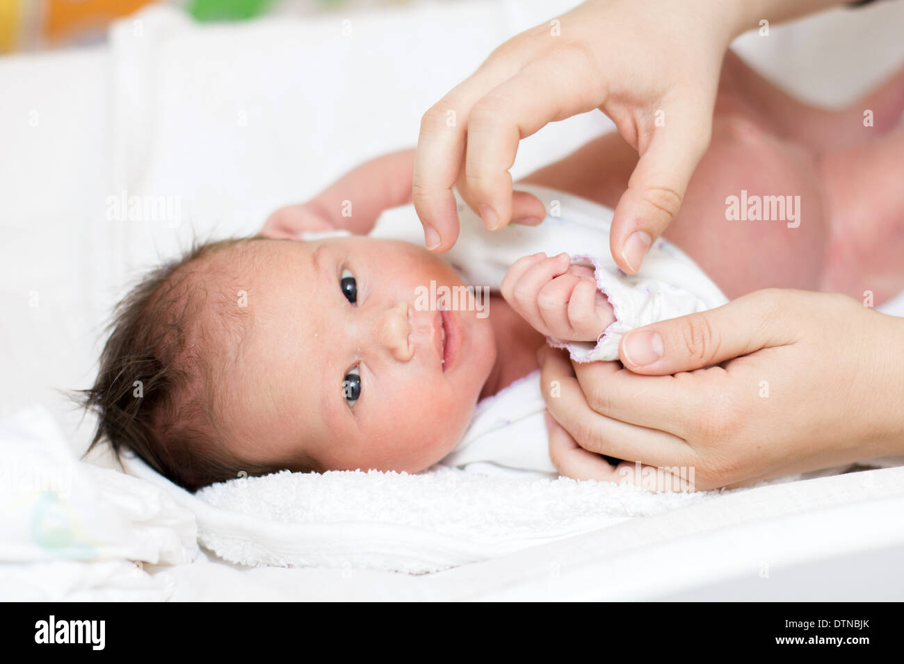 Cute newborn baby looking at camera Stock Photo - Alamy