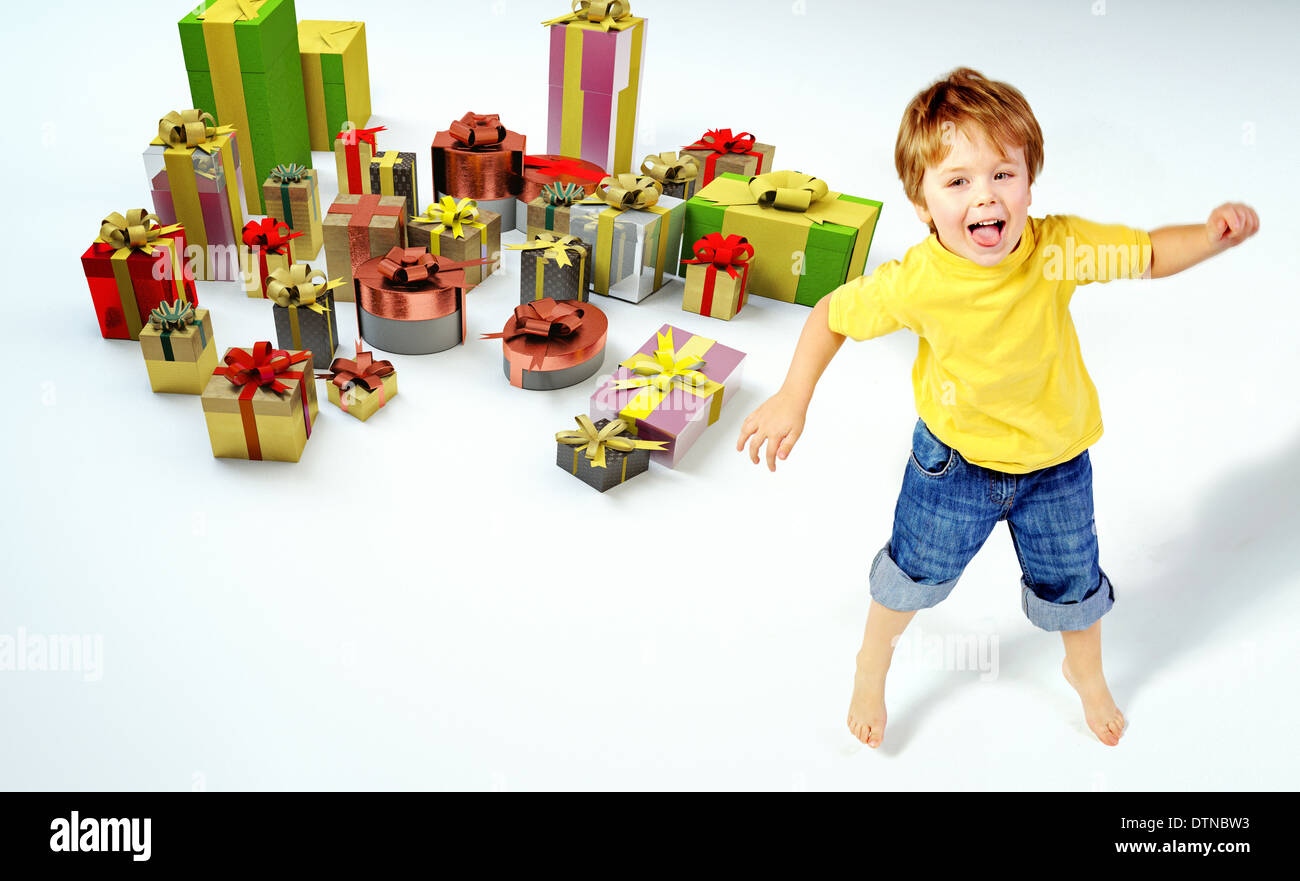 Amazed little boy with lots of gifts Stock Photo - Alamy