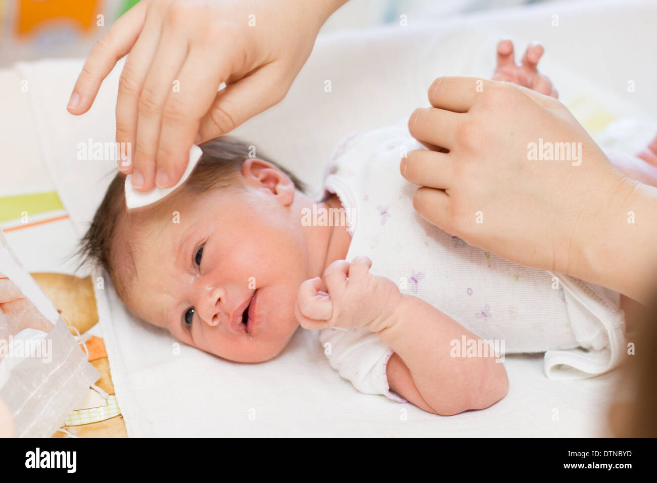 Mother cleaning newborn baby skin Stock Photo - Alamy