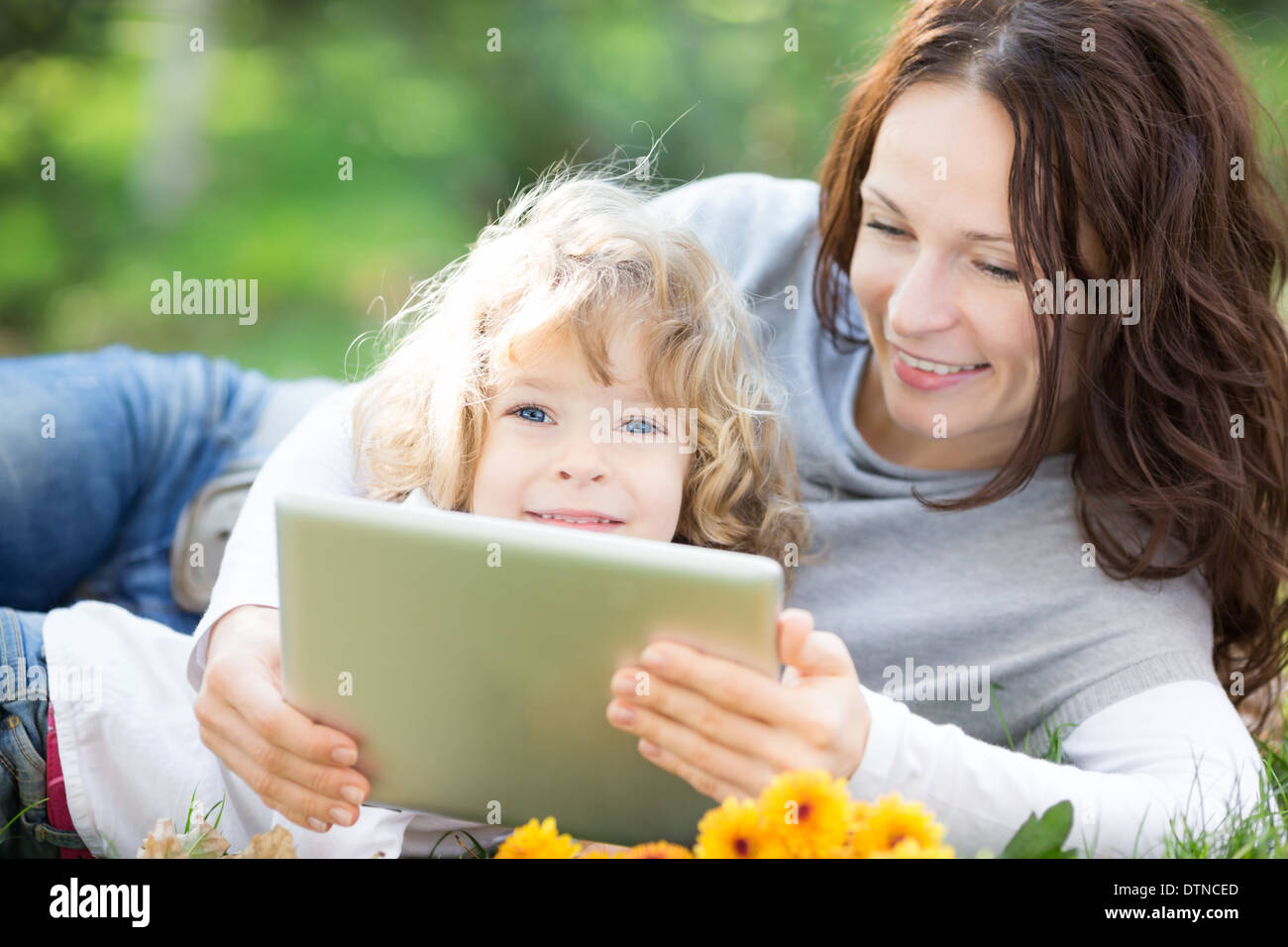Family using tablet PC outdoors Stock Photo - Alamy