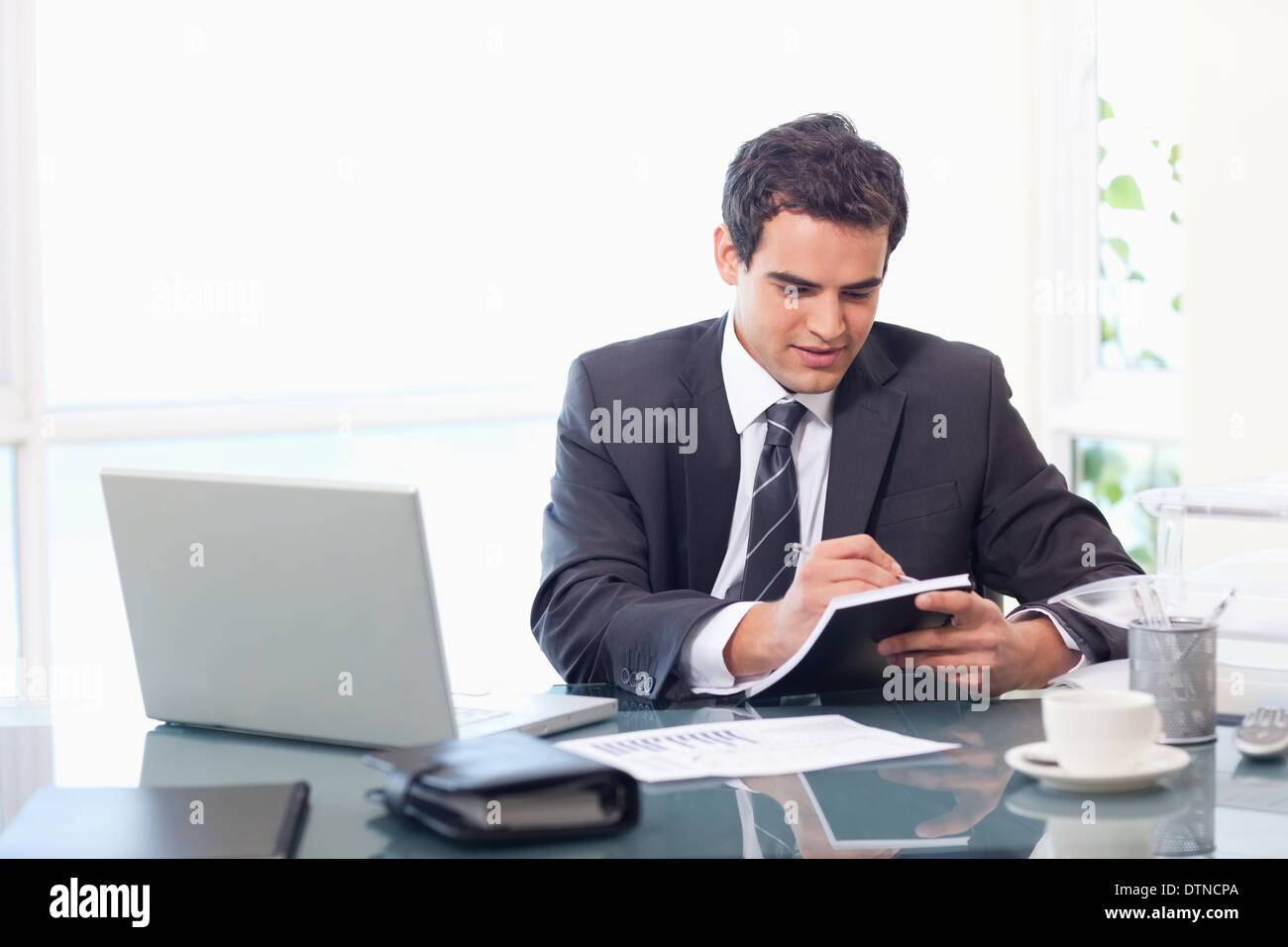 Businessman taking notes Stock Photo - Alamy