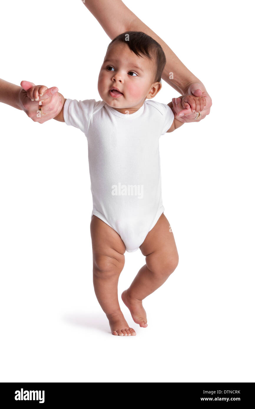 First steps of a baby girl on white background Stock Photo - Alamy