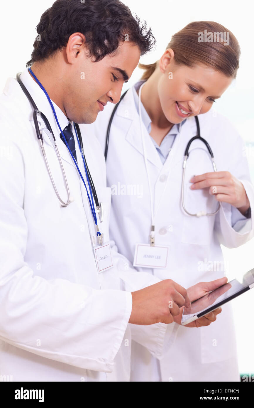 Young assistant doctors using tablet Stock Photo - Alamy