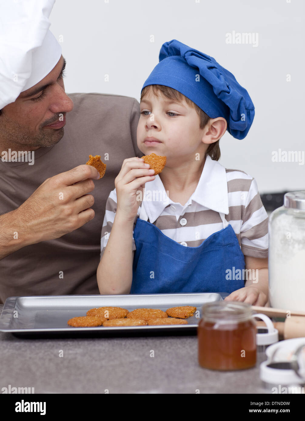 Father and son eating cookies Stock Photo - Alamy