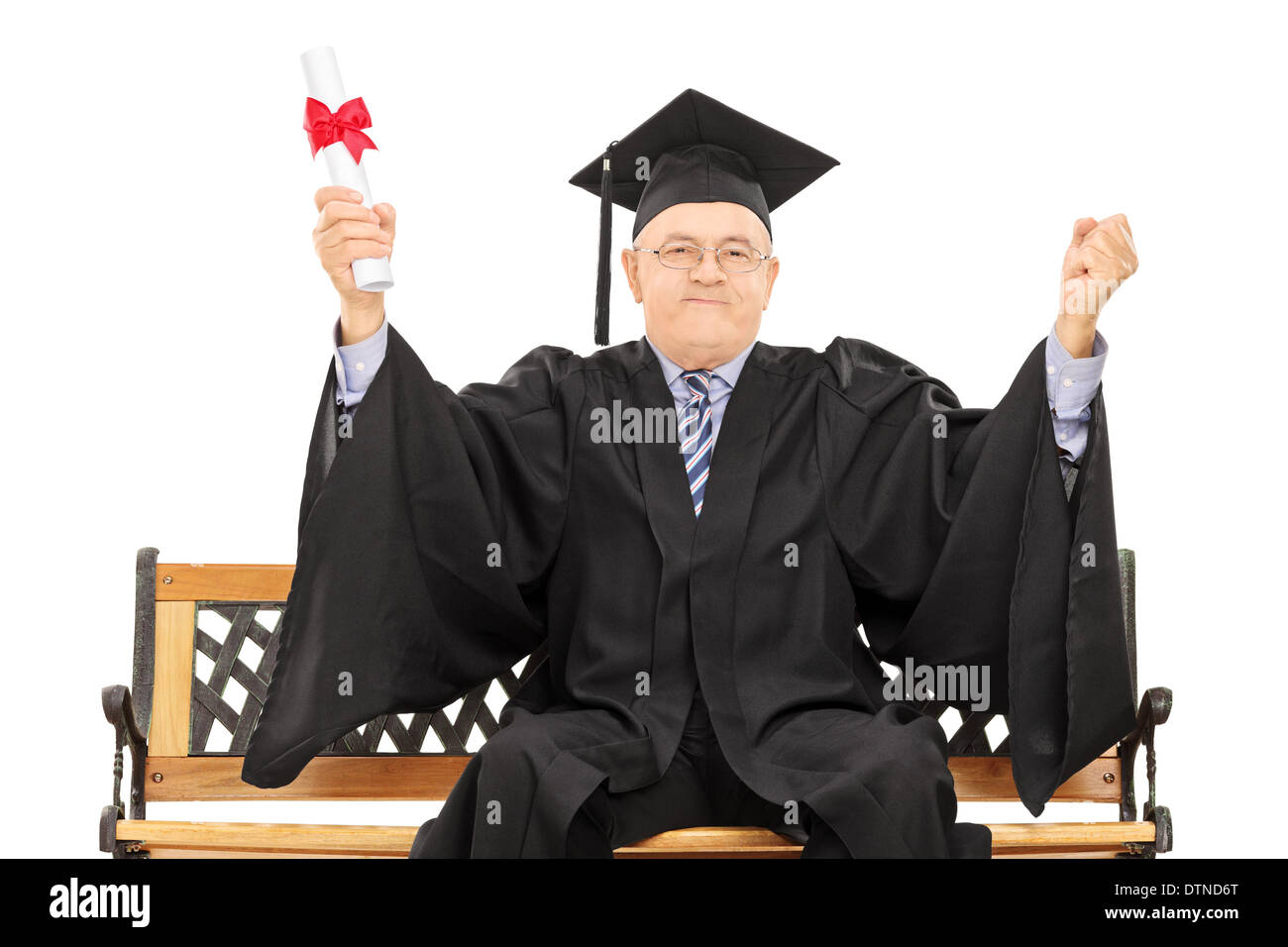 Mature man celebrating his graduation seated on wooden bench Stock ...