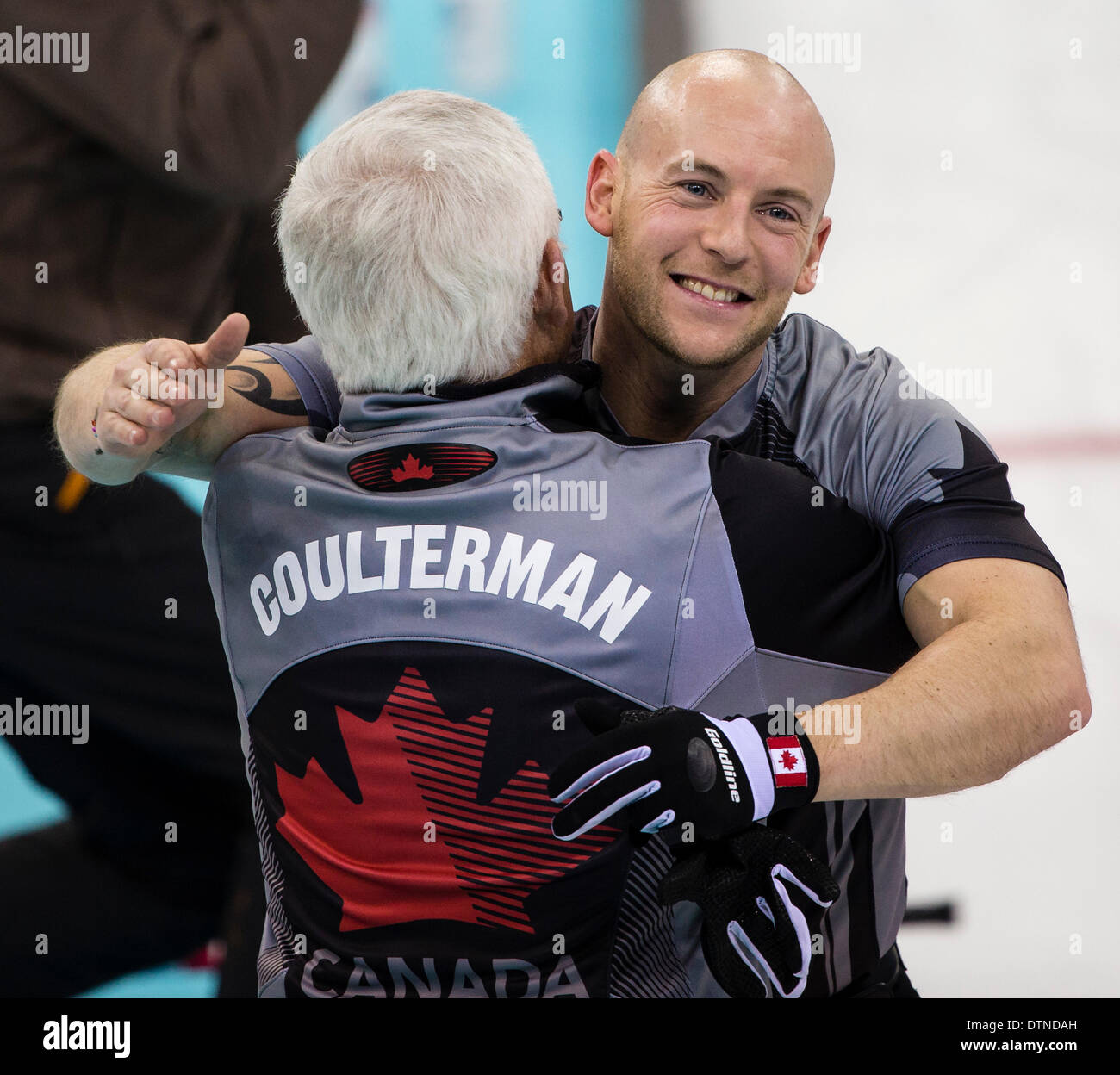 Sochi, Russia. 21st Feb 2014. Canada vice-skip Ryan FRY hugged by Coach ...