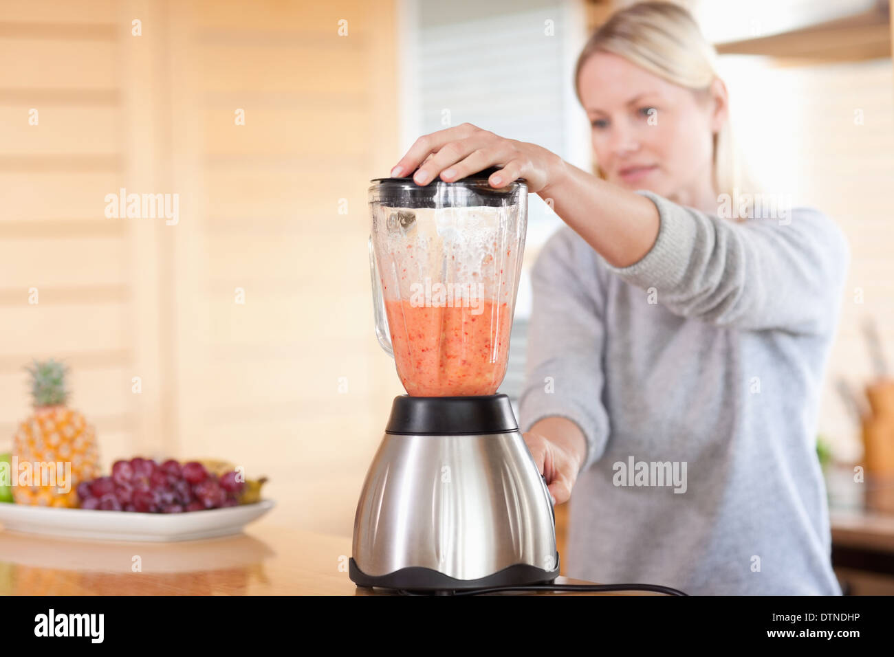 Side view of blender chopping fruits Stock Photo - Alamy