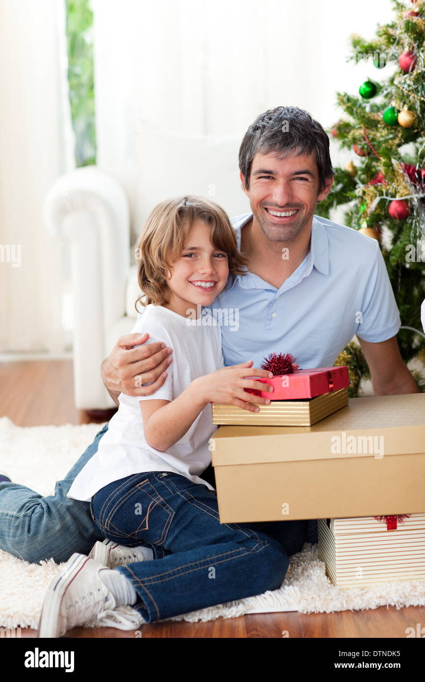 Father and his son holding Christmas gifts Stock Photo - Alamy