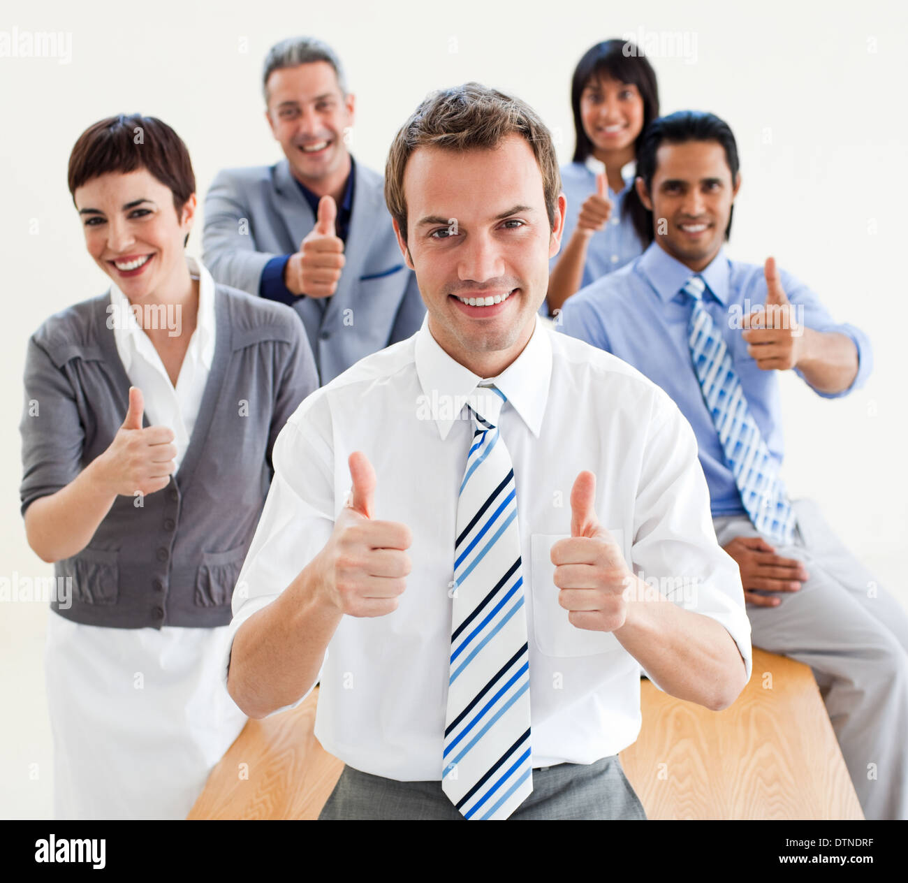 Fortunate business people with thumbs up Stock Photo - Alamy
